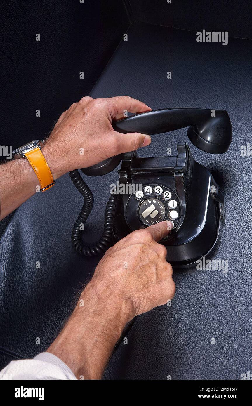 Male hands dial a phone number on a vintage rotary telephone Stock ...