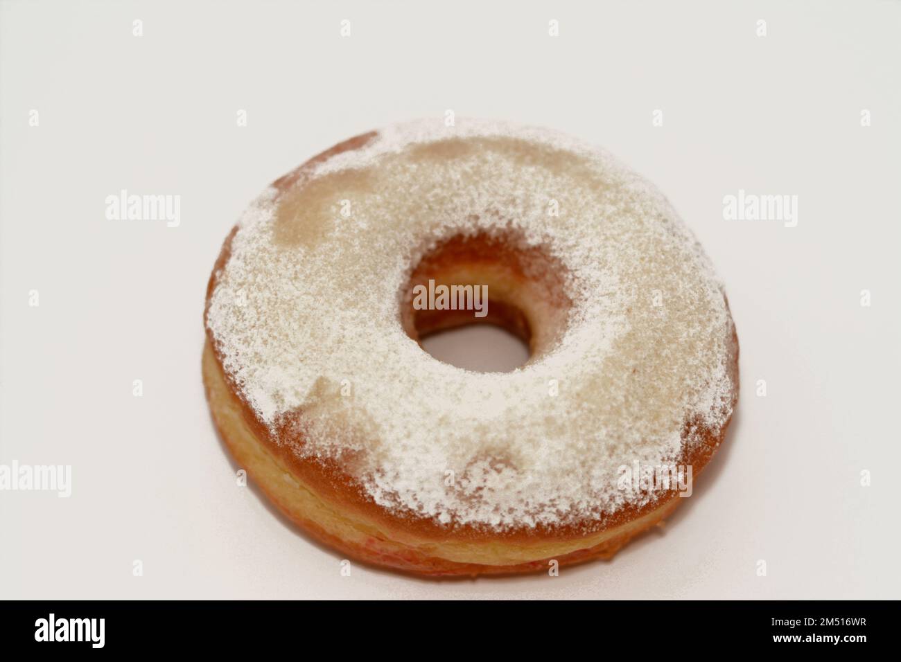 Powdered icing sugar ring donut, A glazed, yeast raised, American style ...