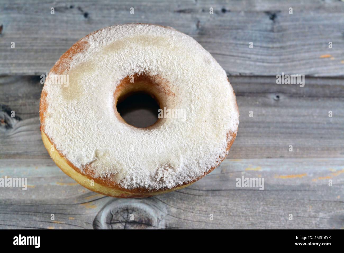 Powdered icing sugar ring donut, A glazed, yeast raised, American style ...