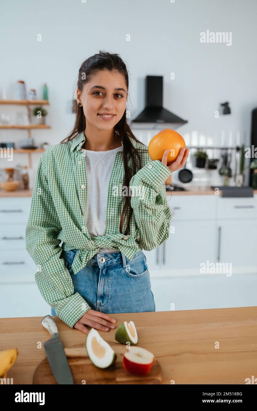 Happy healthy woman making breakfast in a kitchen Stock Photo - Alamy
