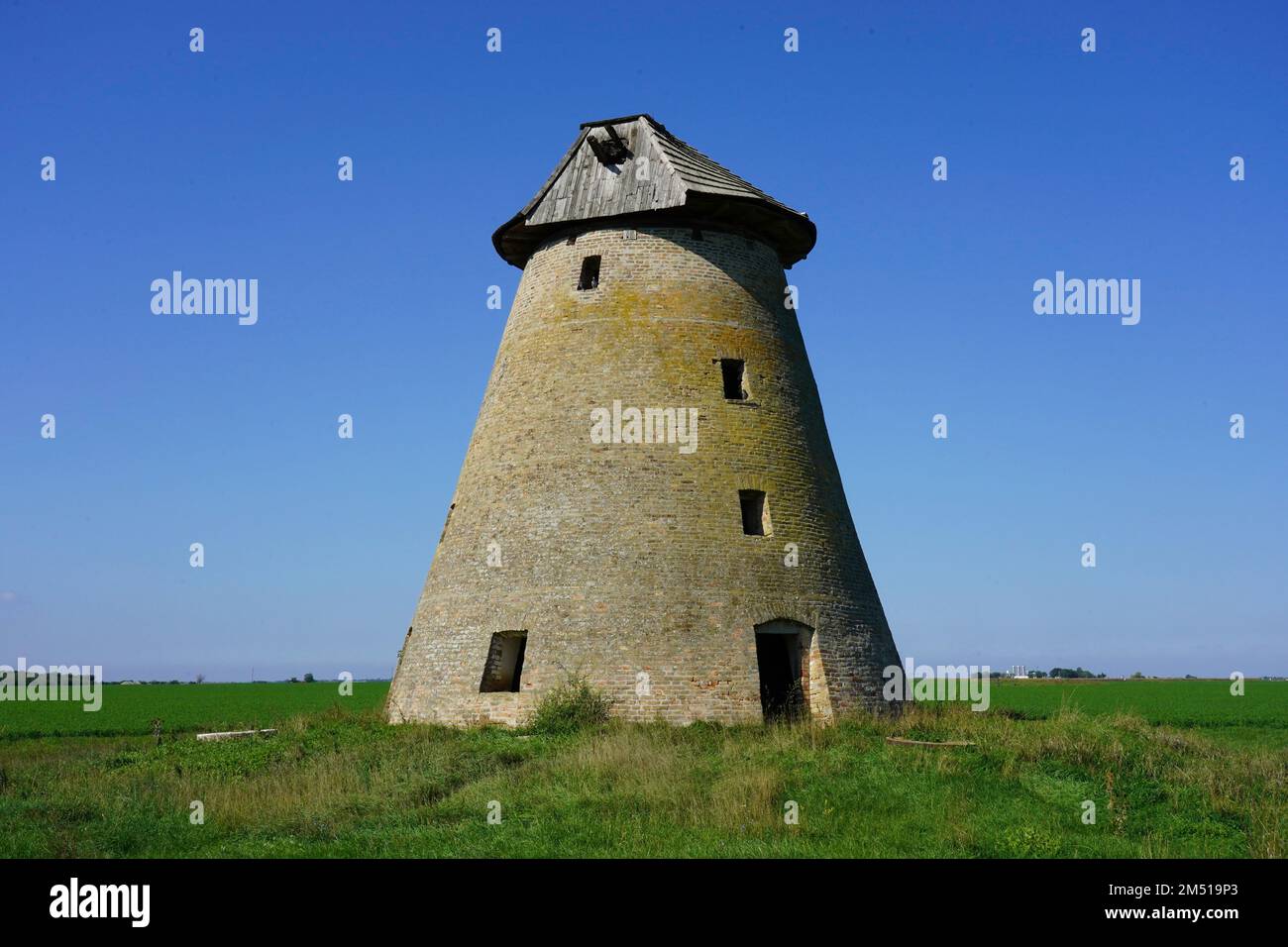 A medieval windmill building against clear blue sky Stock Photo - Alamy