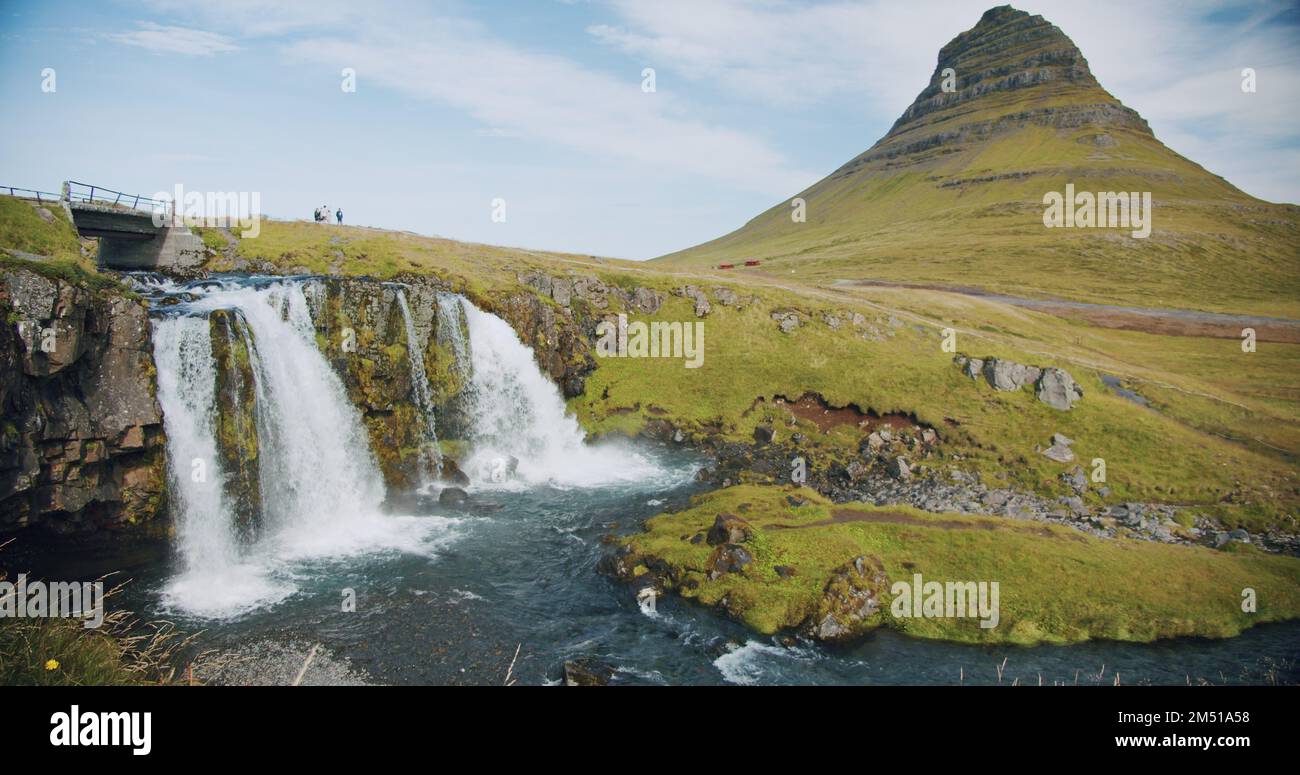 Green mountain peak and Kirkjufellsfoss fall is popular attractions at ...