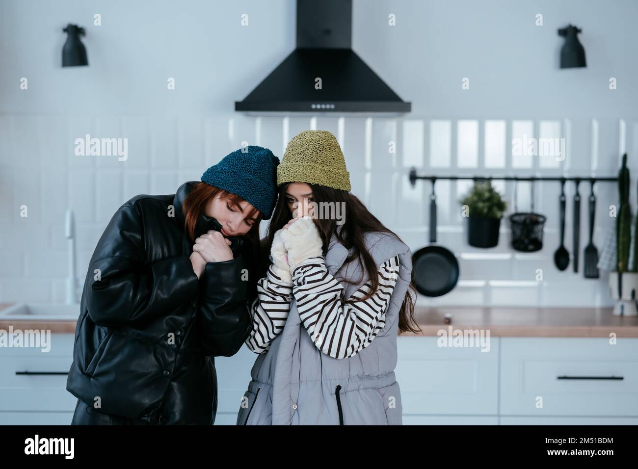 Warmly dressed women are upset with the heating turned off Stock Photo ...