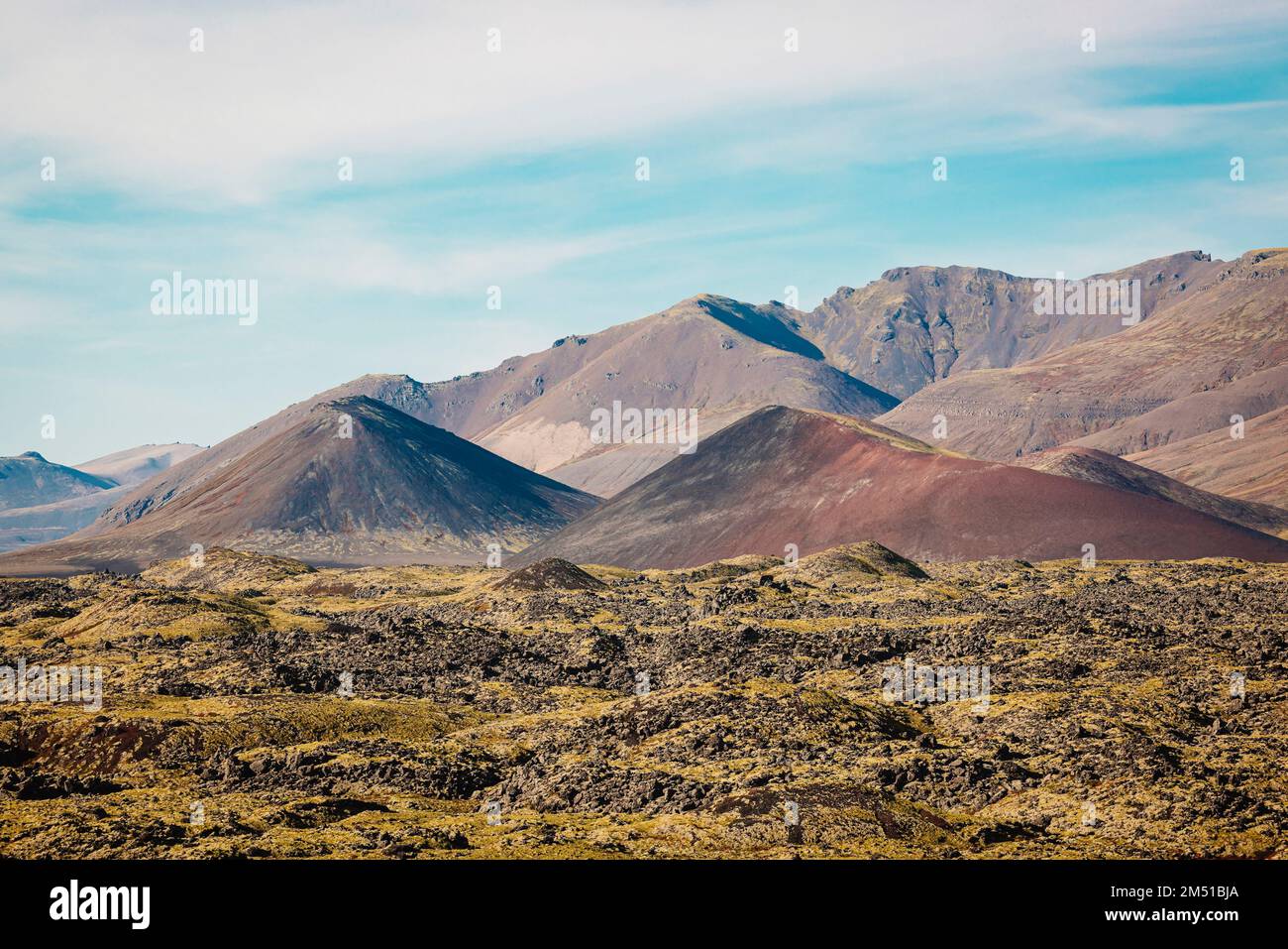Red volcanic mountains near Selvallavatn lake, typical Iceland ...