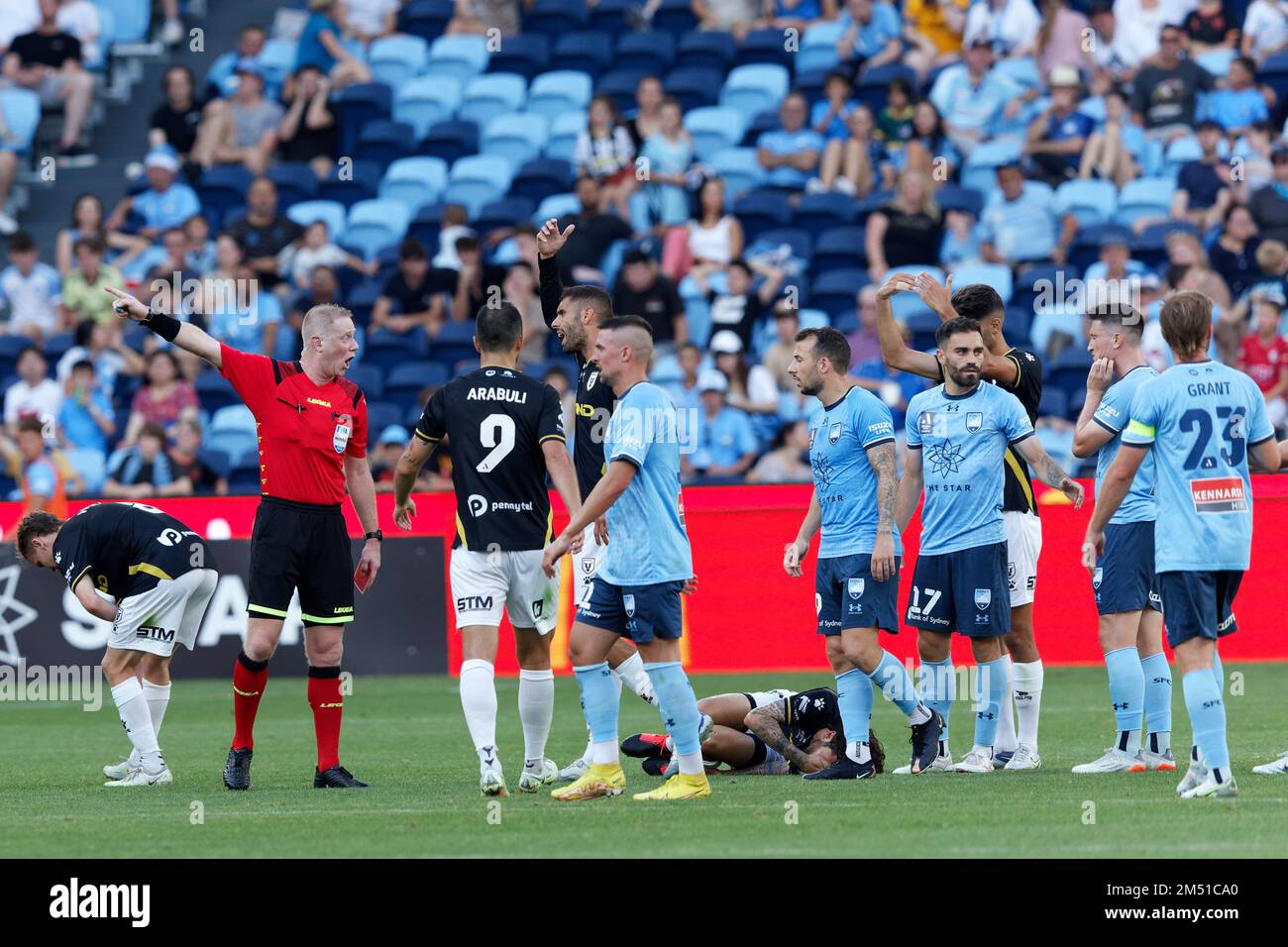 Kurt Ams gives a red card to Joseph Lolley of Sydney FC for a tackle ...
