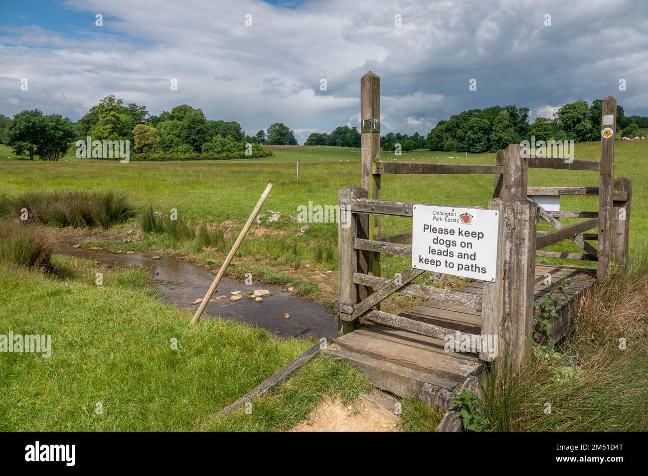 bridge over a stream and The Cotswold Way footpath through Dodington ...