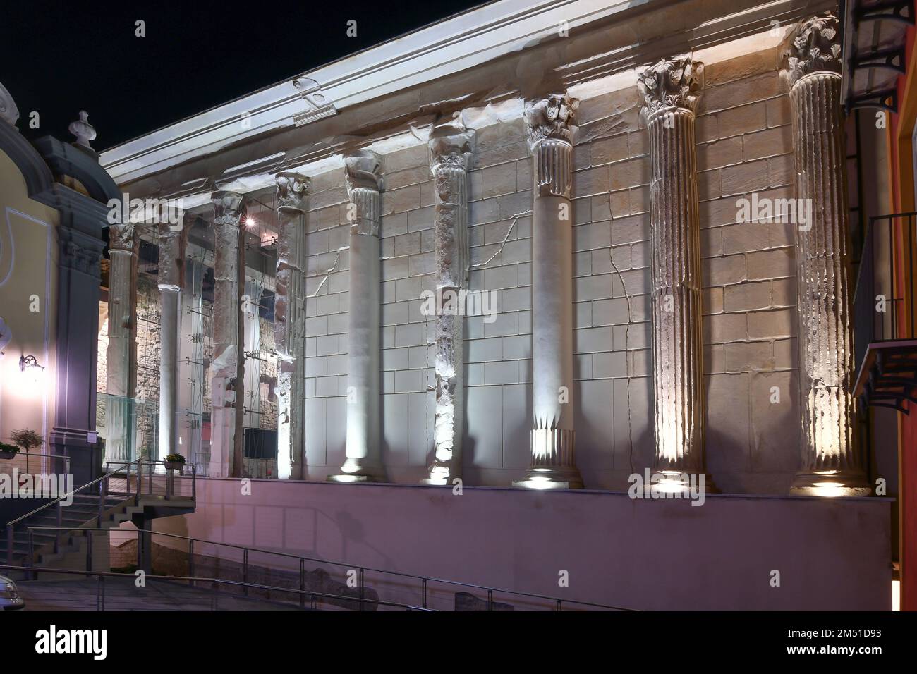 A wall of a medieval church built between the columns of an ancient ...