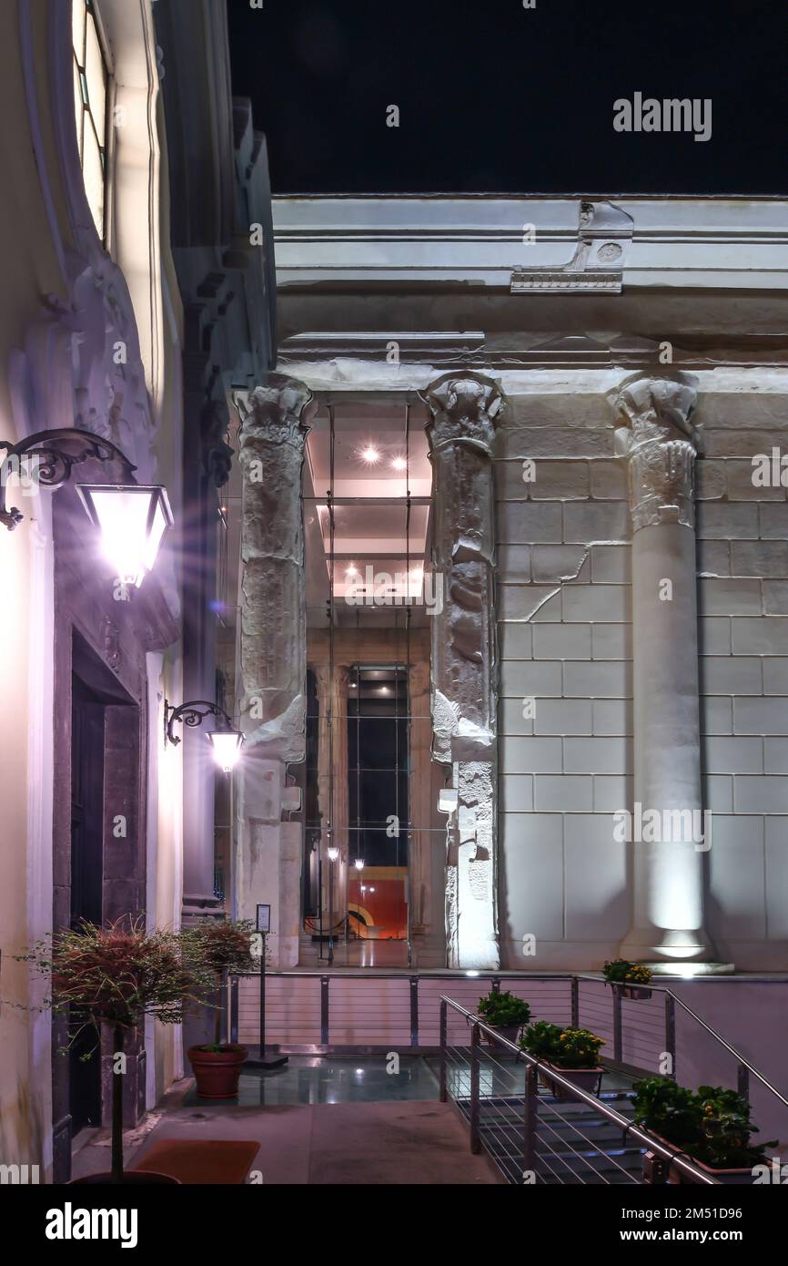 A wall of a medieval church built between the columns of an ancient ...