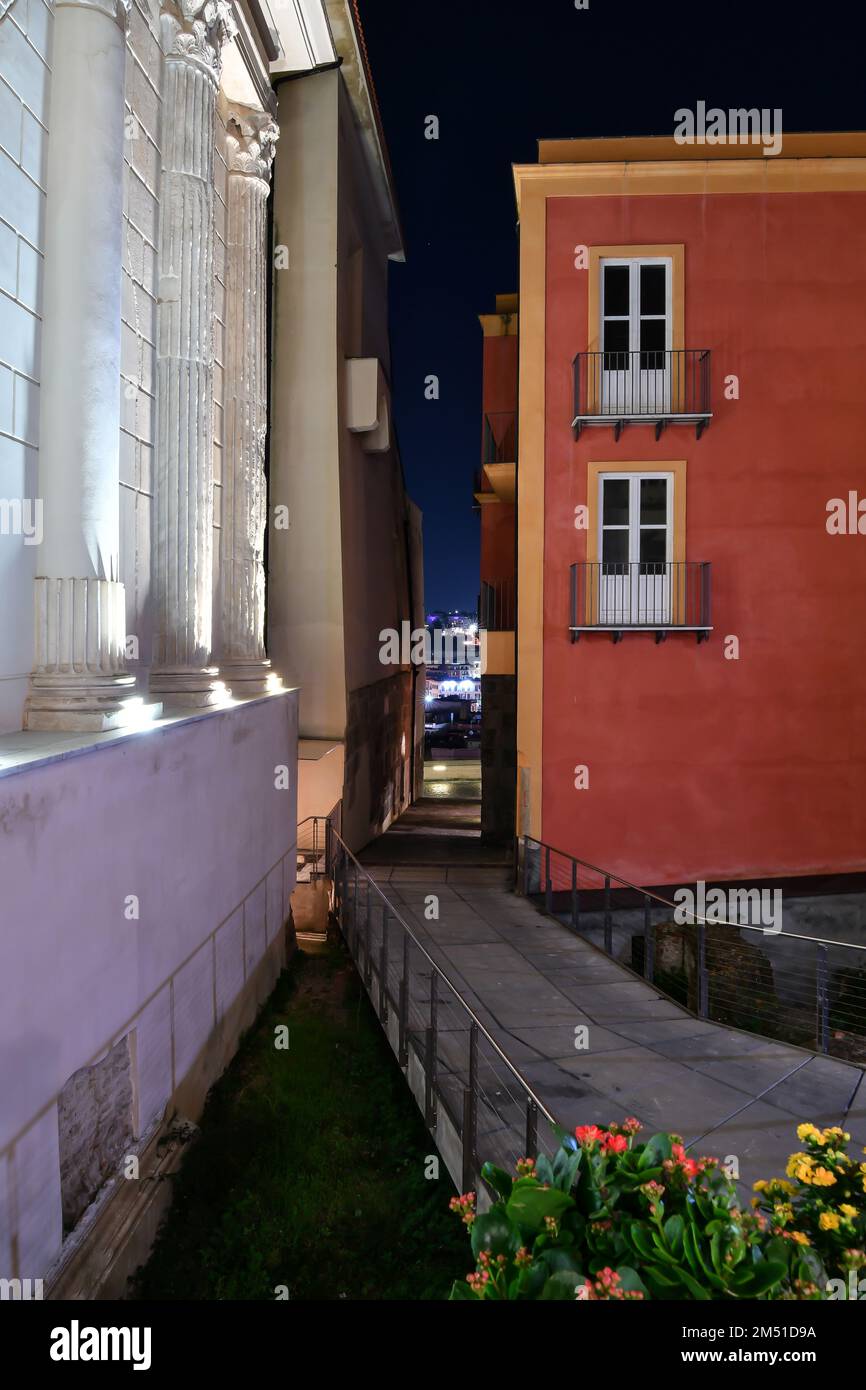 A wall of a medieval church built between the columns of an ancient ...