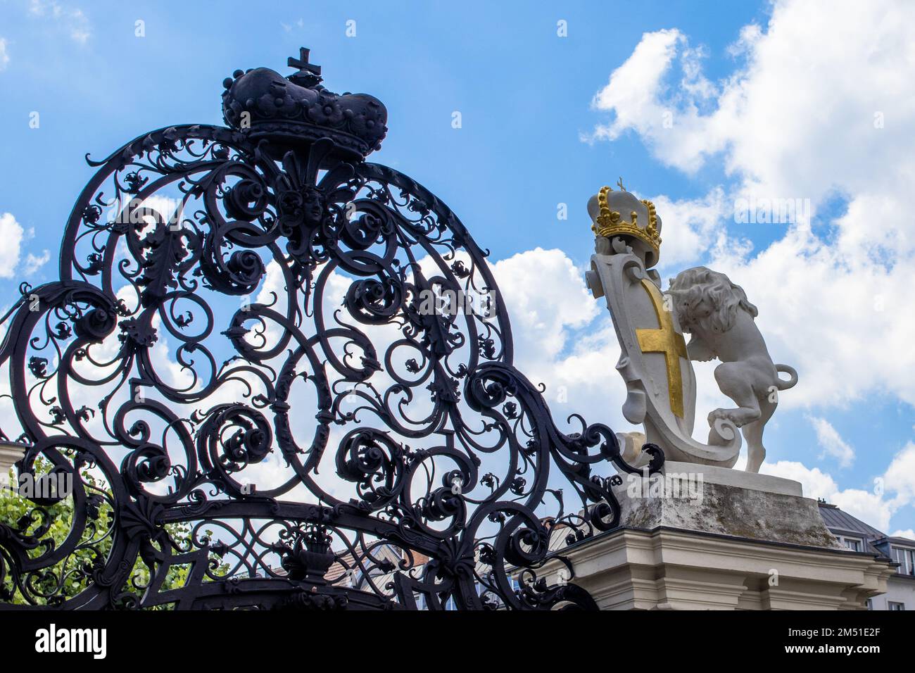 A black gate and a lion statue in the city of Vienna, Austria on a ...