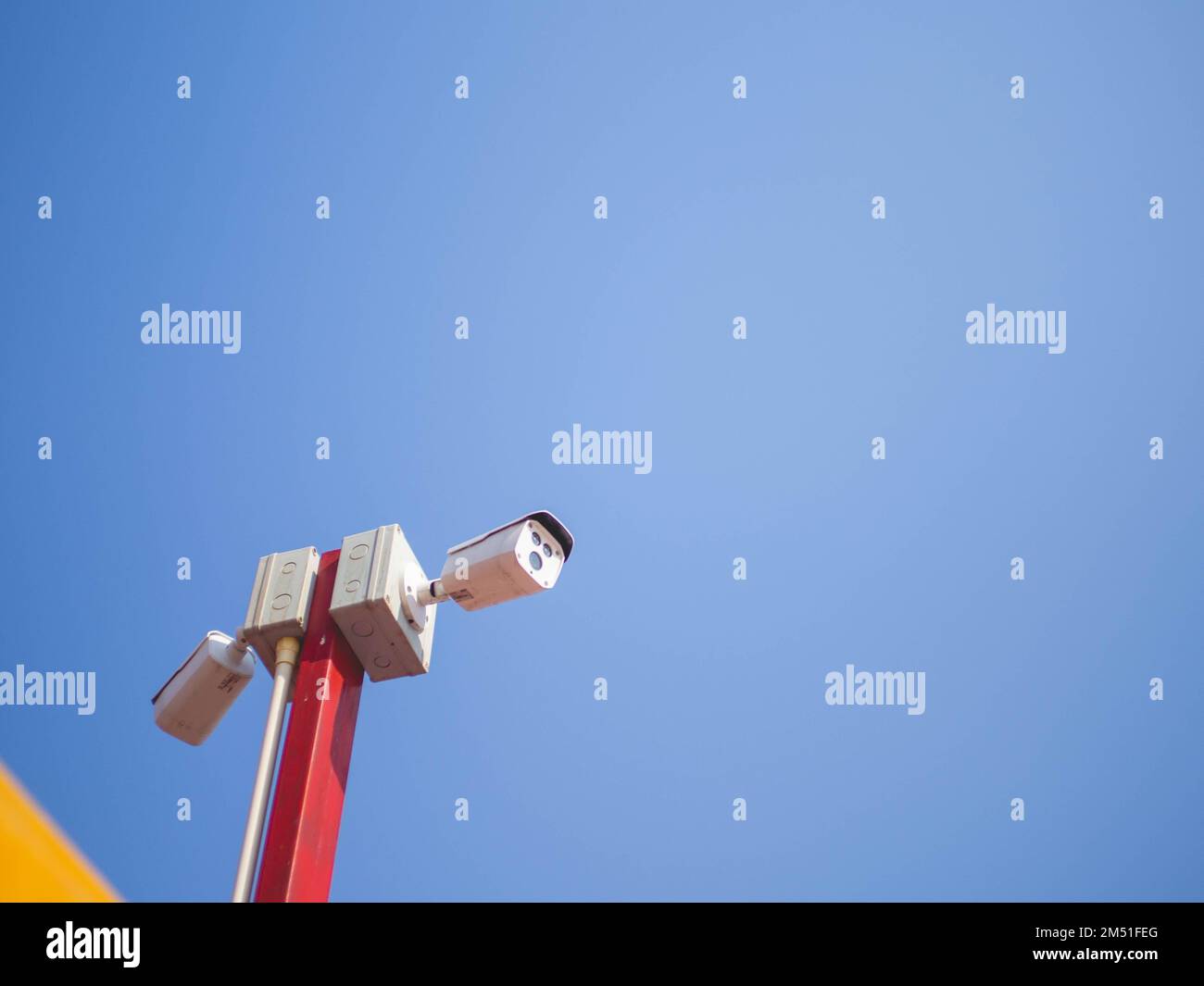 CCTV camera attached to a red pole Stock Photo - Alamy