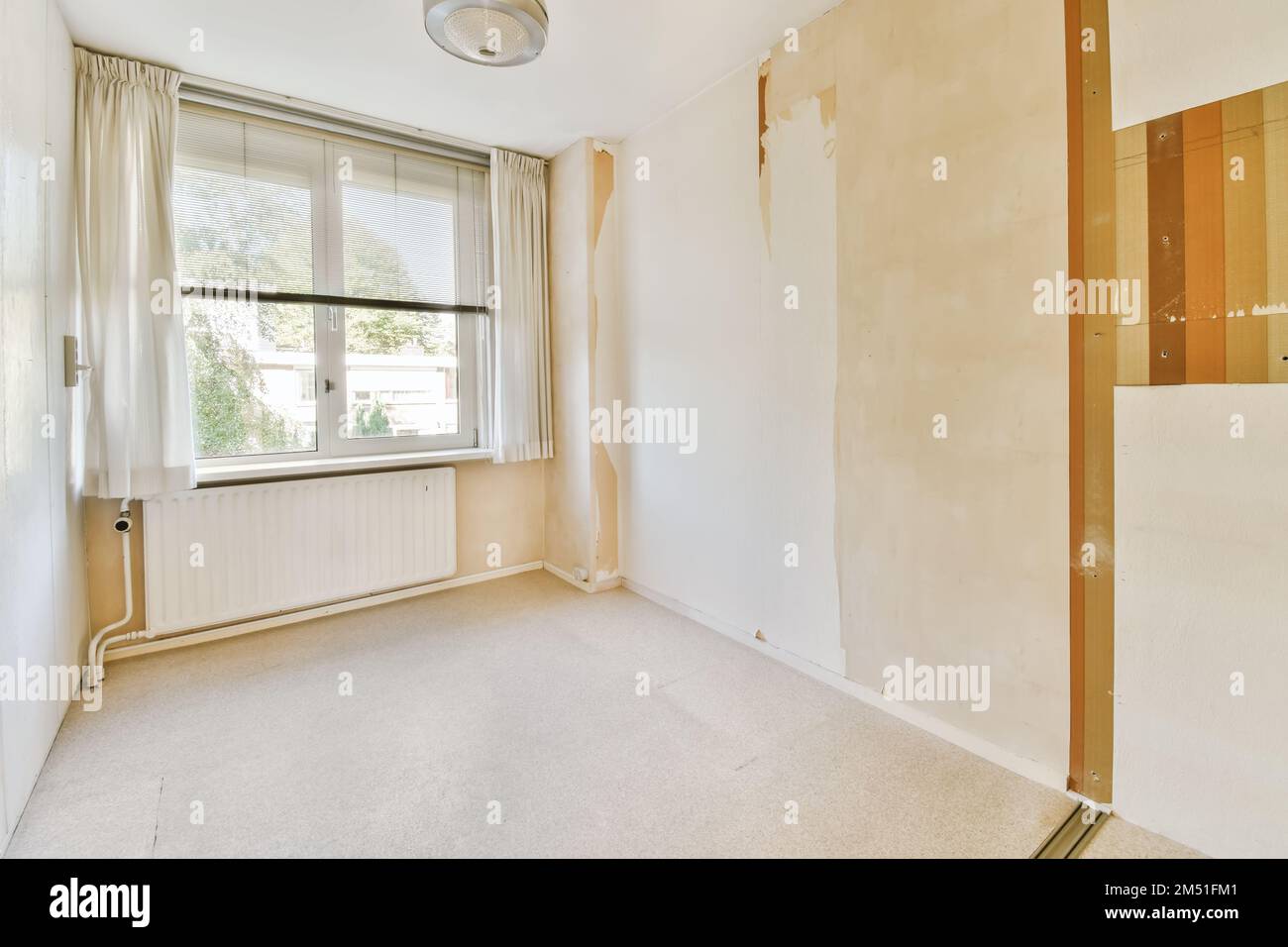 an empty room with white walls and no one window in the photo is taken ...