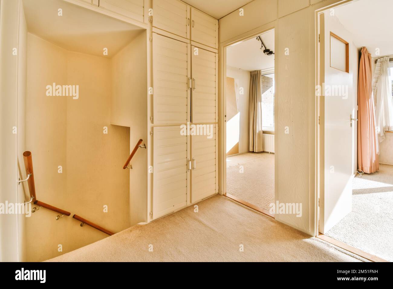 the inside of a room with an open door and clothes hanging on hangers ...