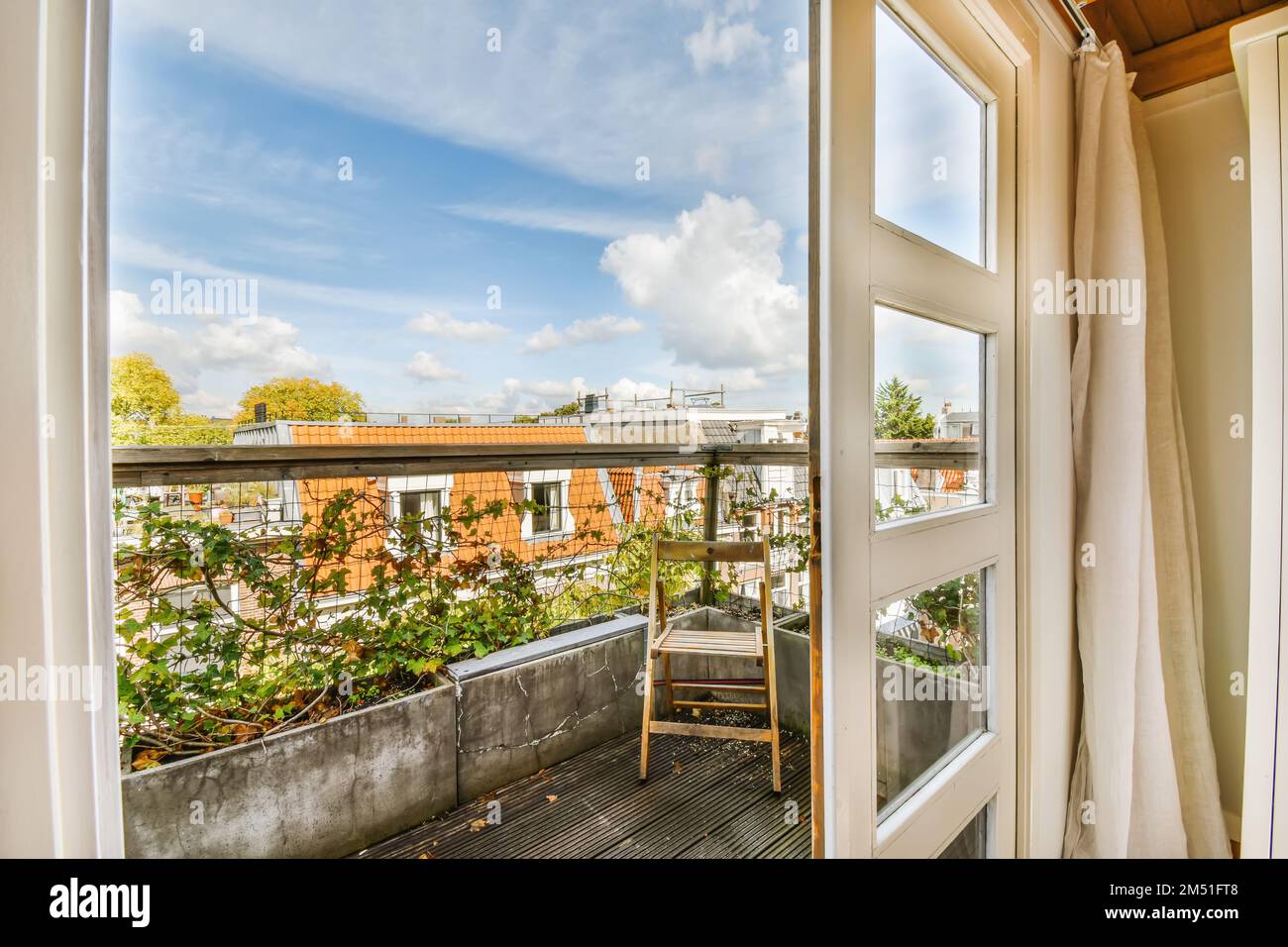 a balcony with a view of the city from it's window sing out to the ...