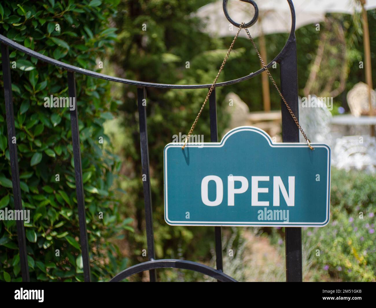 A blue sign with an open word Stock Photo - Alamy