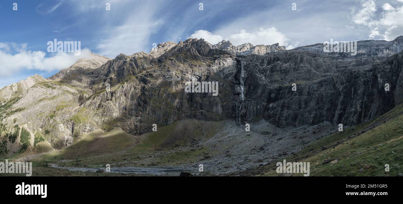 Panorama of Cirque de Gavarnie with waterfall at massive high rock wall ...