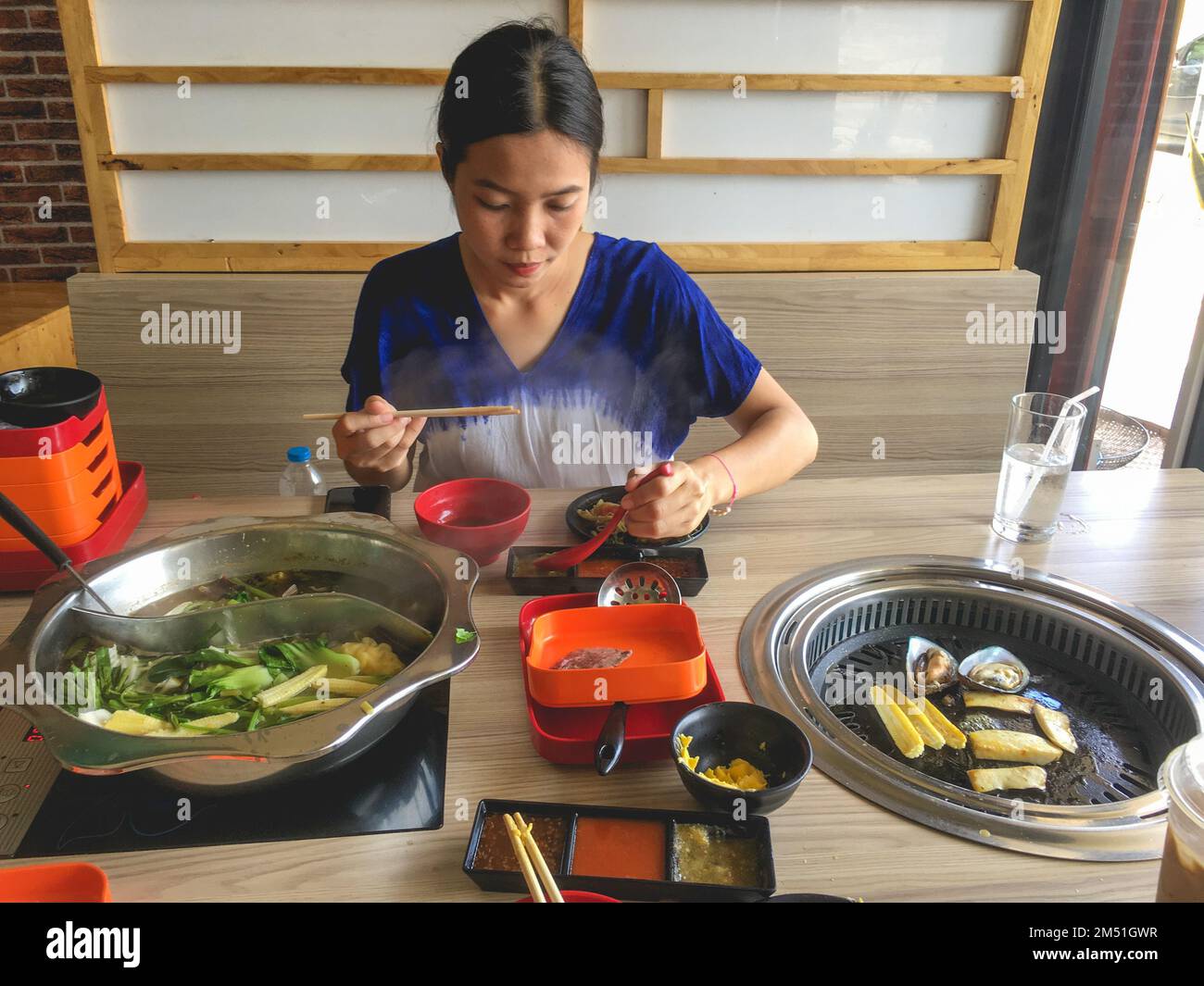 woman eating a variety of foods Stock Photo - Alamy