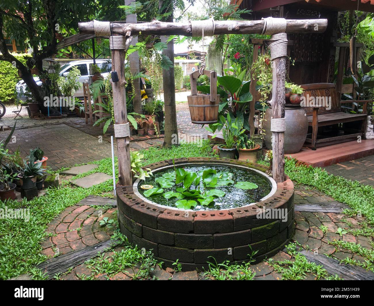 Old water wells and wooden diggers Stock Photo - Alamy