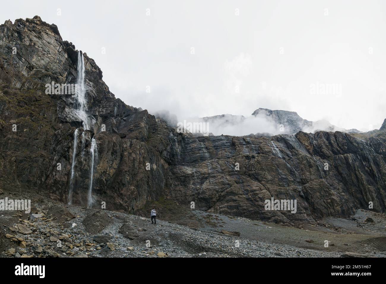 Panorama of Cirque de Gavarnie with big waterfall and small person at ...