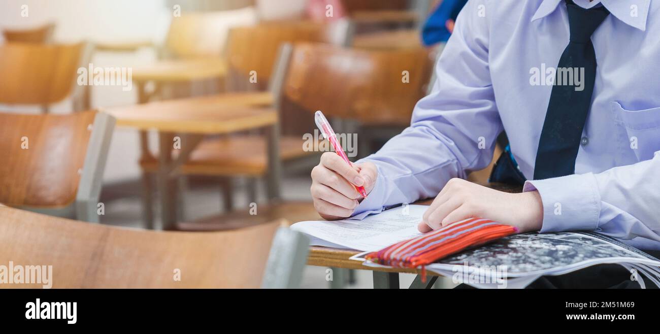 A panoramic shot of a college student writing on final examination ...