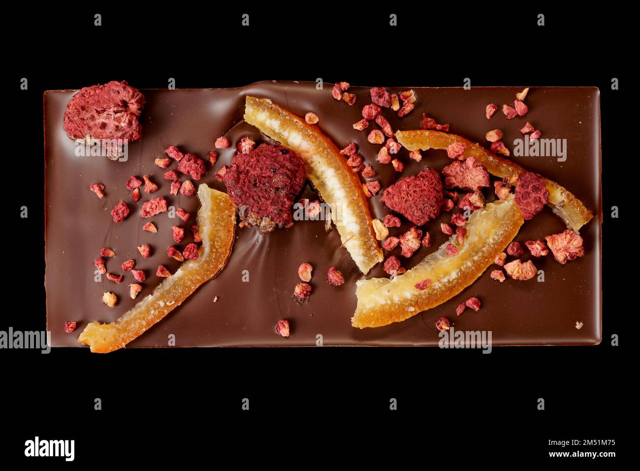 Chocolate bar with candied orange peel and raspberry isolated on black ...