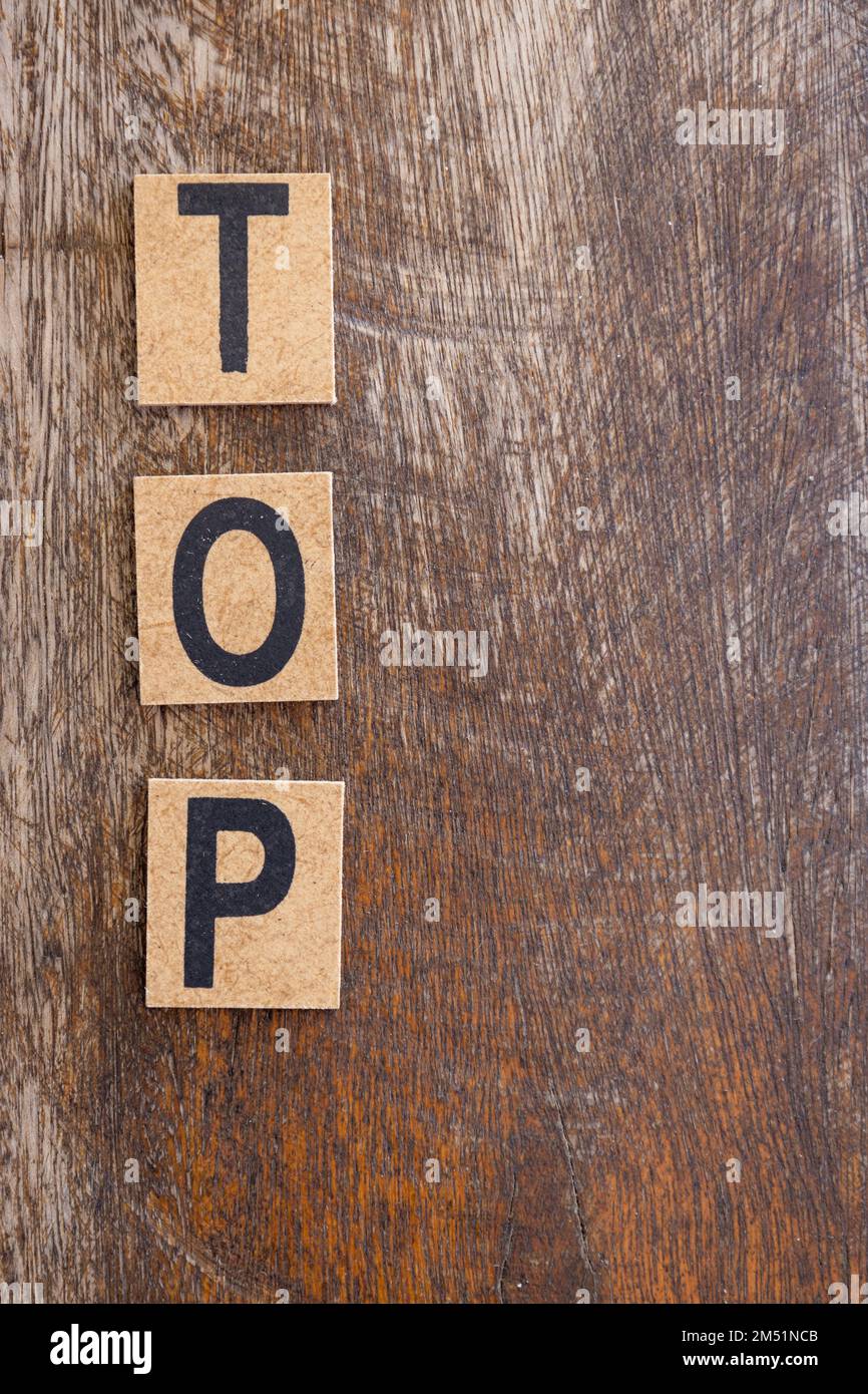 The word top written in small wooden blocks on a rustic background ...