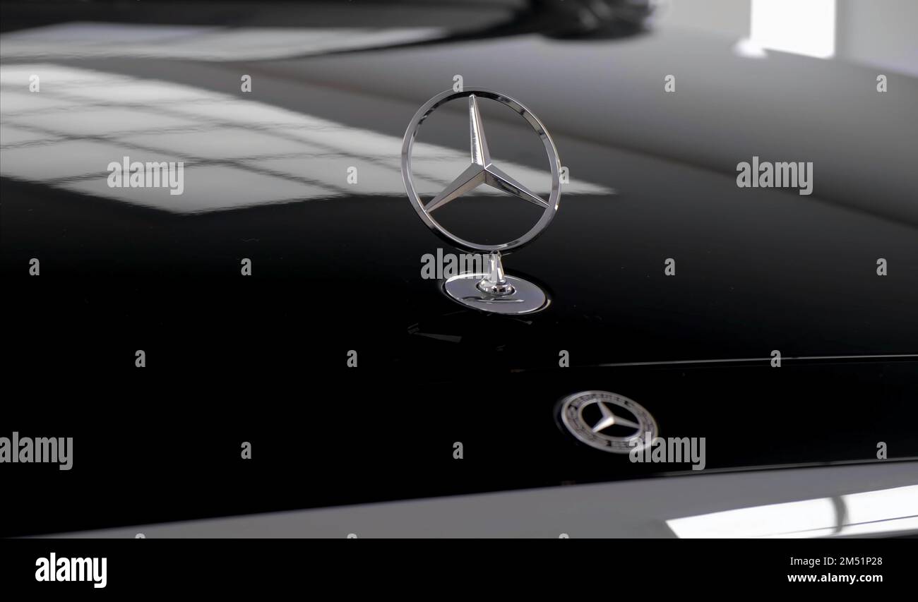 A closeup shot of the front logo of a beautiful black Mercedes Benz S ...