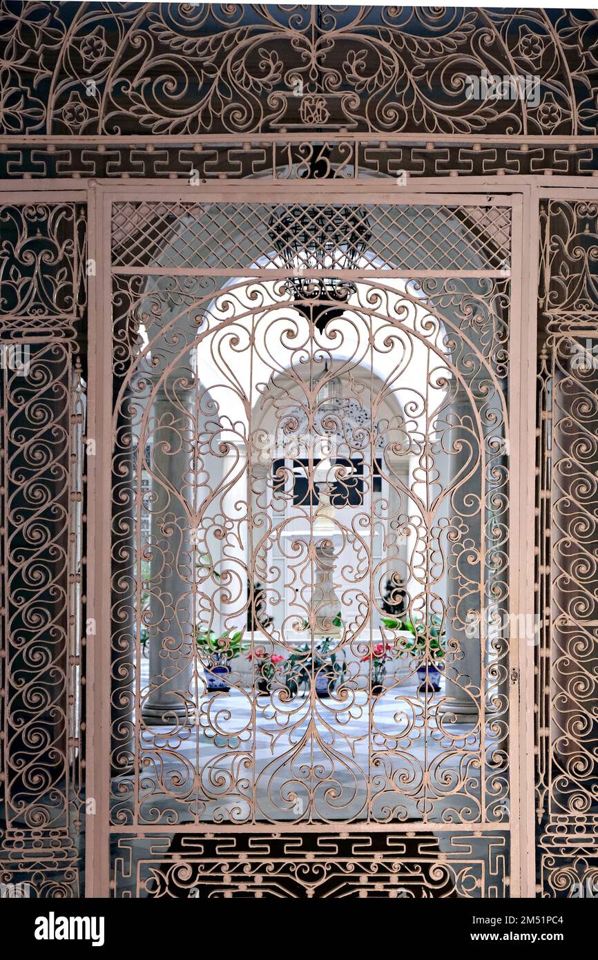 View of a typical patio behind decorated iron gate. Closed but open to ...