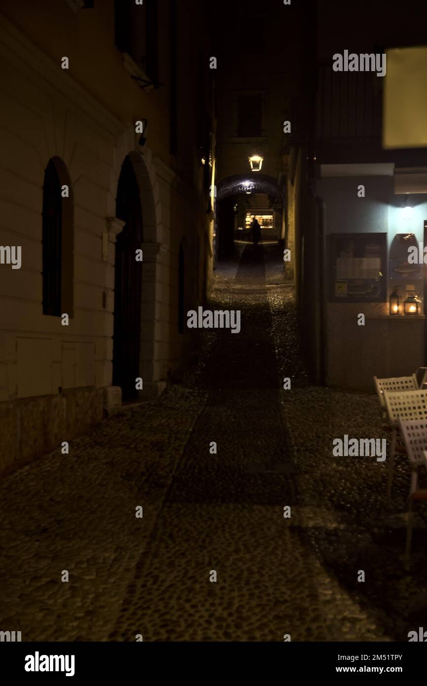 Square with restaurant and people dining at night Stock Photo - Alamy