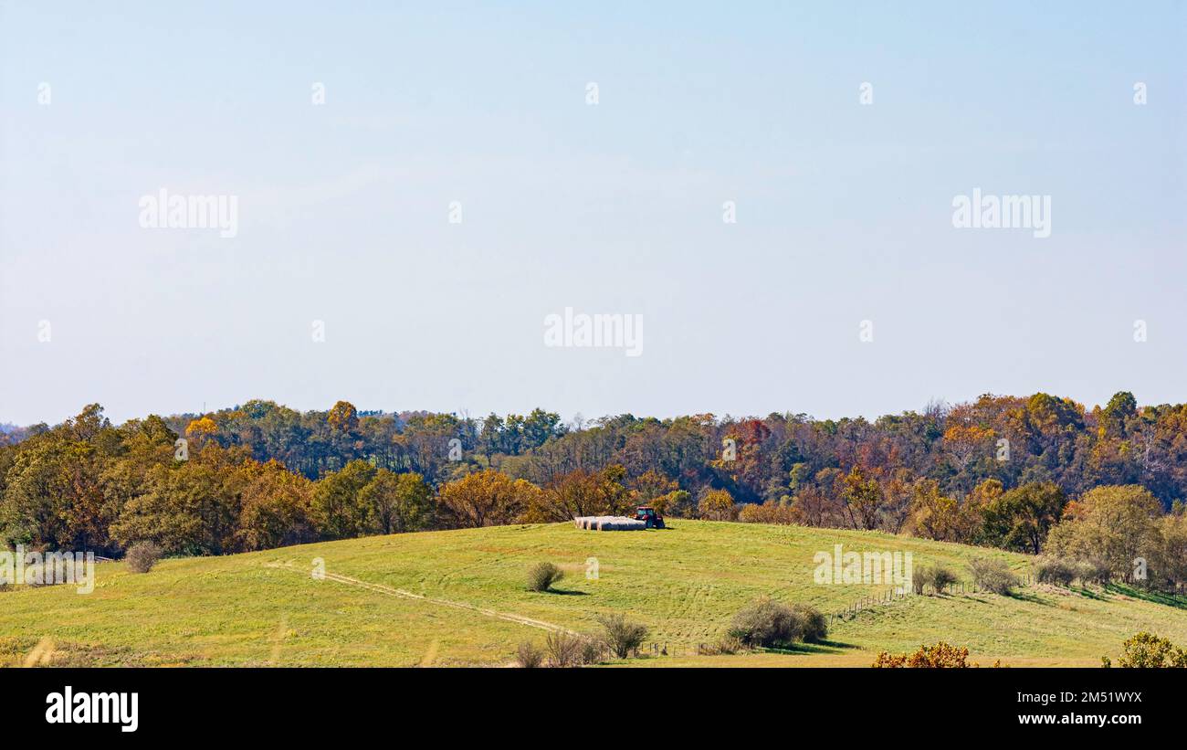 Countryside landscape of rural Ohio hilltop in autumn with round hay ...