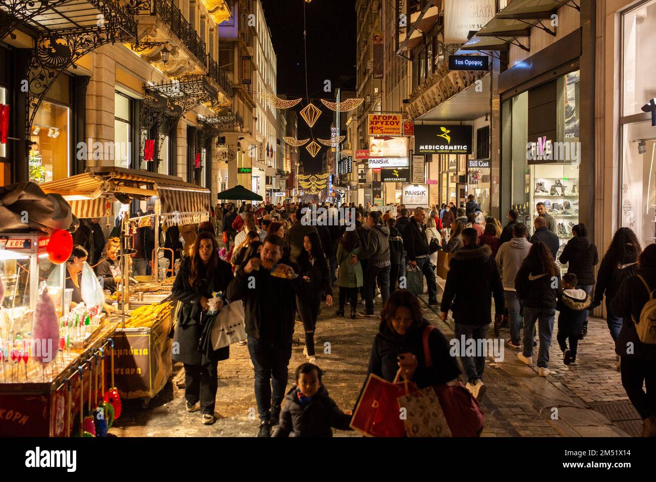 Athen, Greece. 24th Dec, 2022. People walk on Ermou Street, the main ...