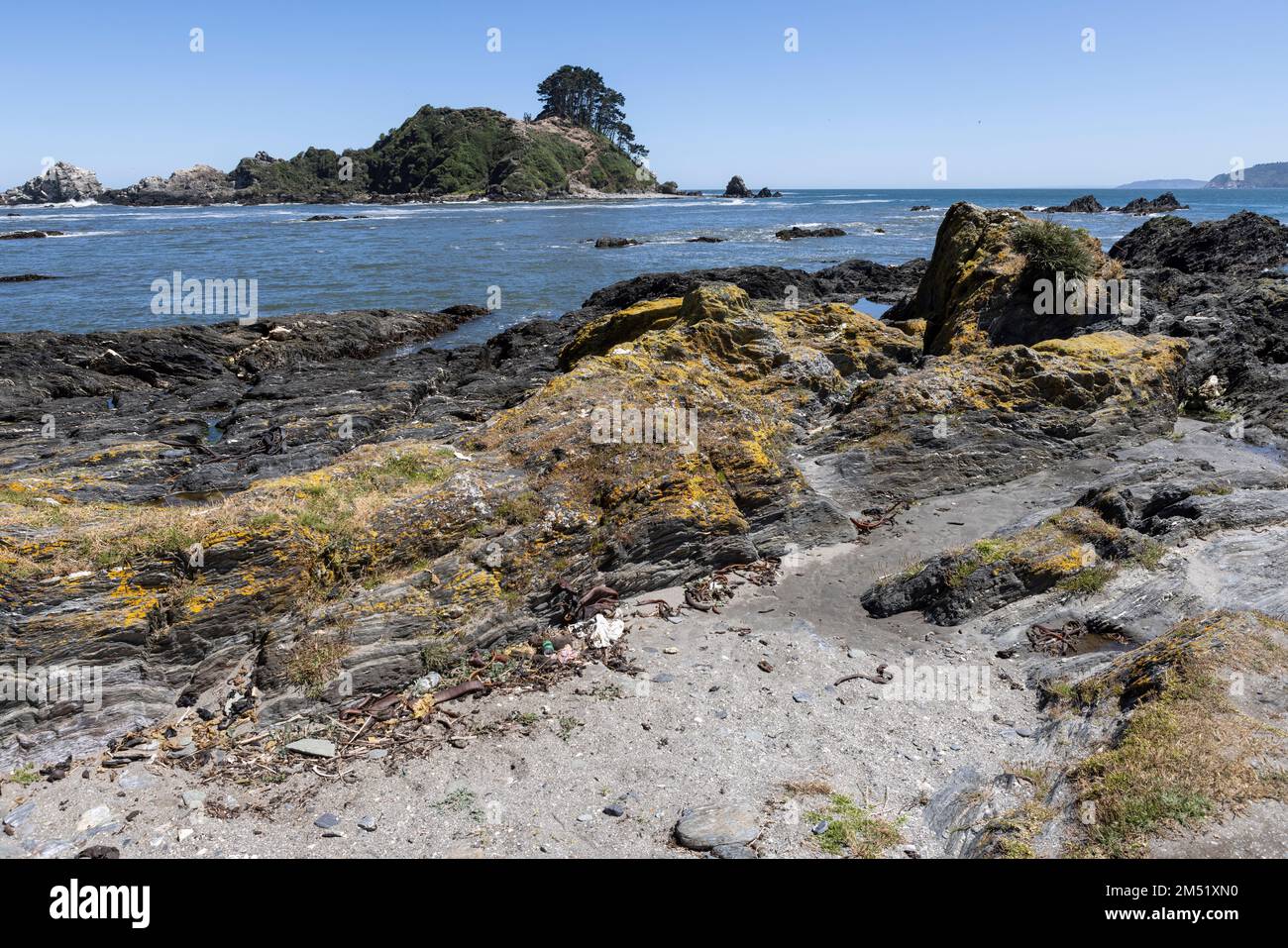 Isla Maiquillahue and big, serrated rocks in the Pacific Ocean of Chile ...