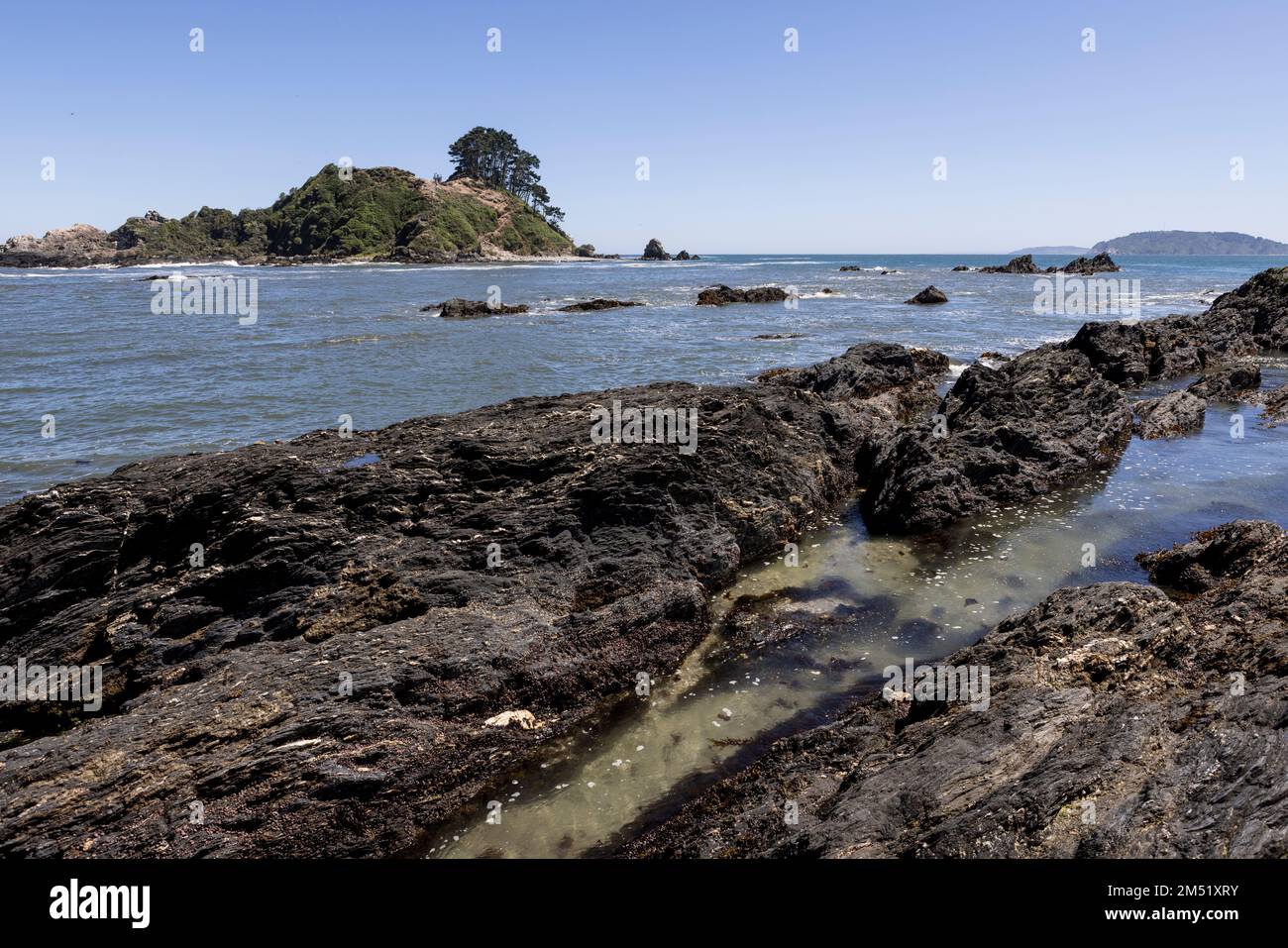 Isla Maiquillahue and big, serrated rocks in the Pacific Ocean of Chile ...
