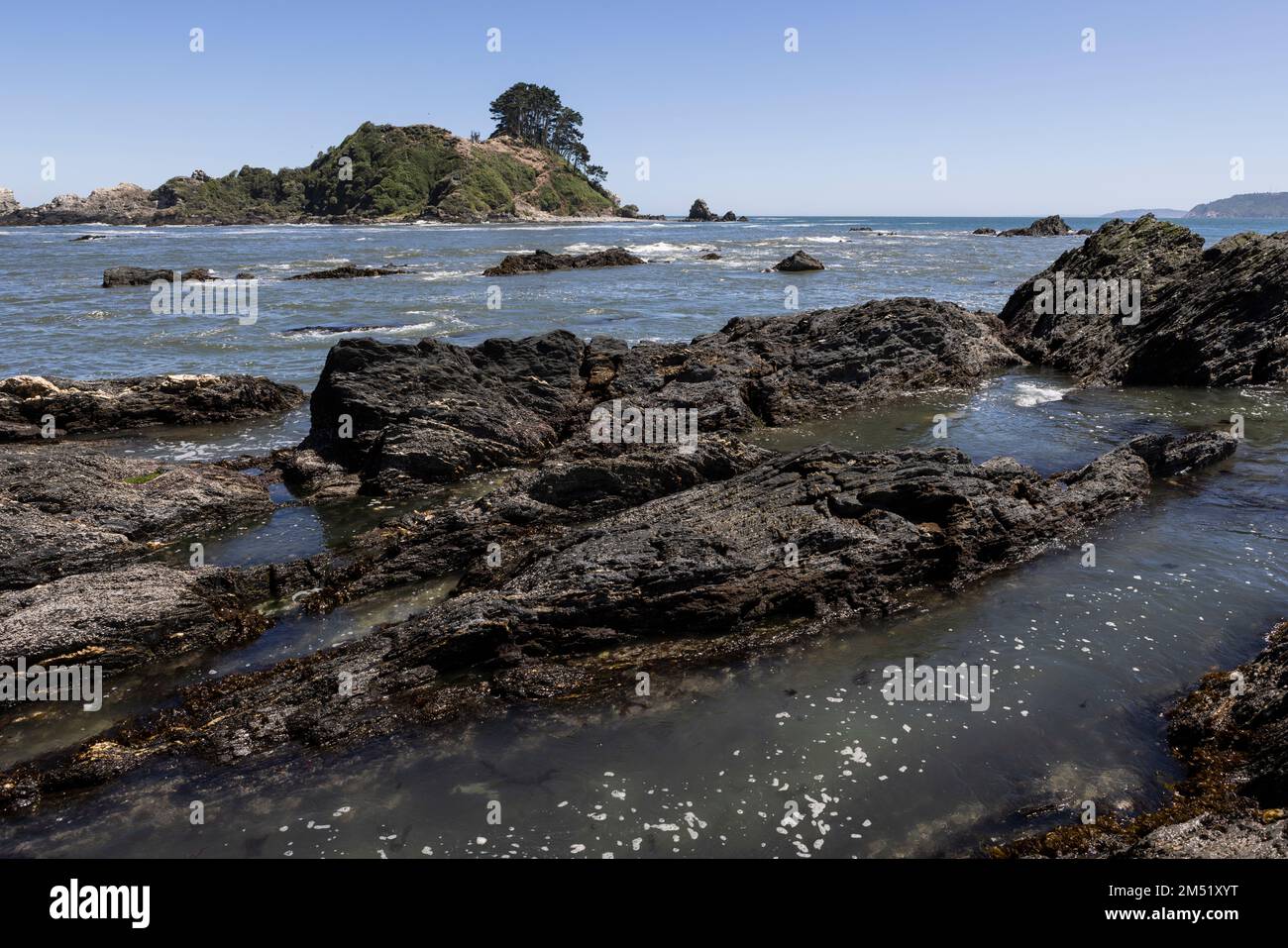 Isla Maiquillahue and big, serrated rocks in the Pacific Ocean of Chile ...