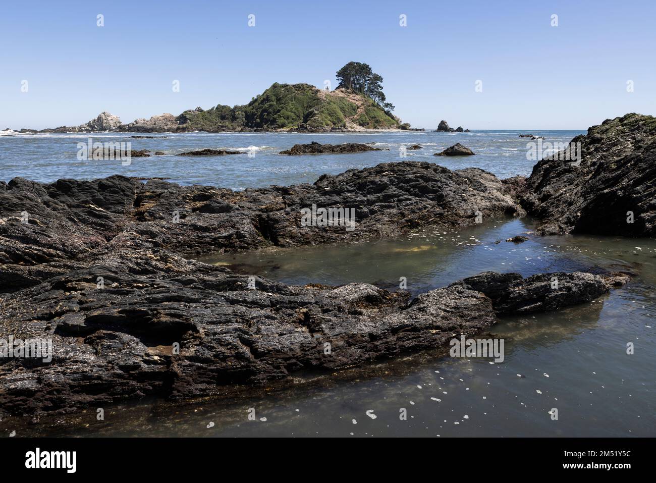 Isla Maiquillahue and big, serrated rocks in the Pacific Ocean of Chile ...