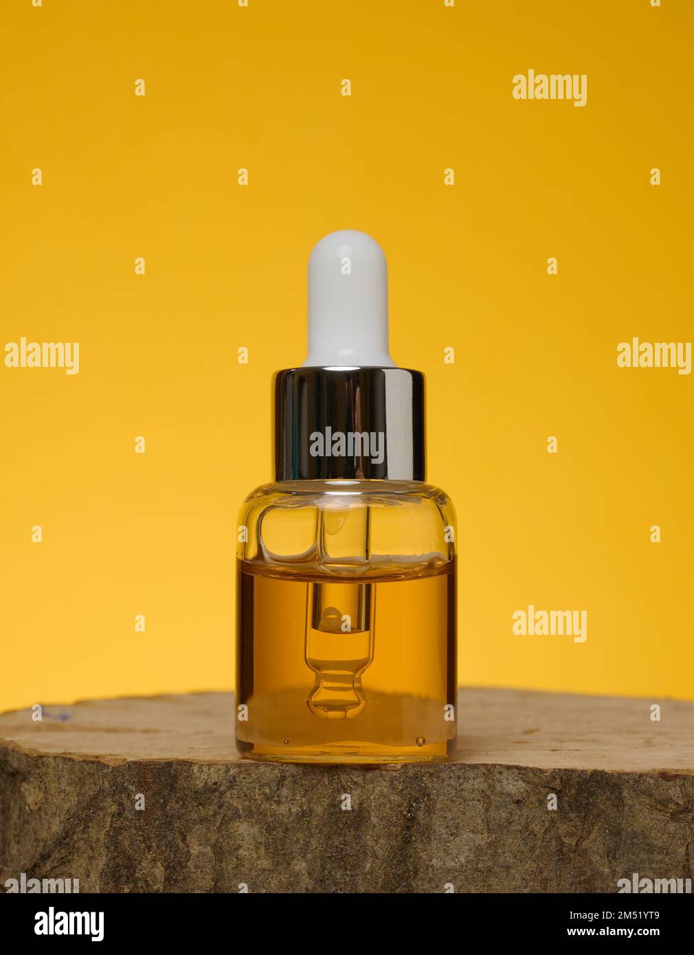 Glass transparent bottle with pipette and yellow oil. Containers for ...