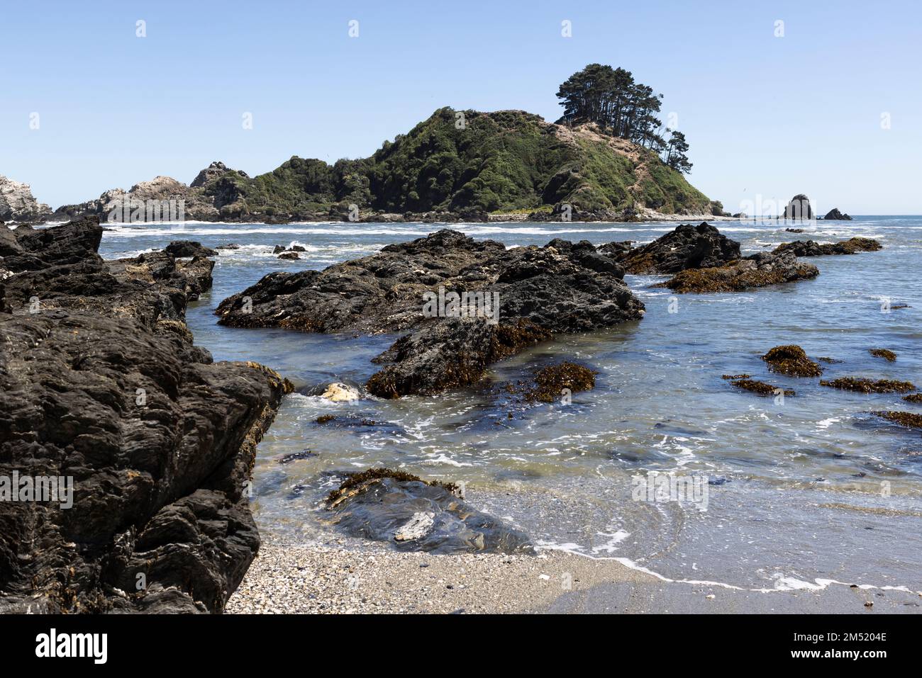 Isla Maiquillahue and big, serrated rocks in the Pacific Ocean of Chile ...