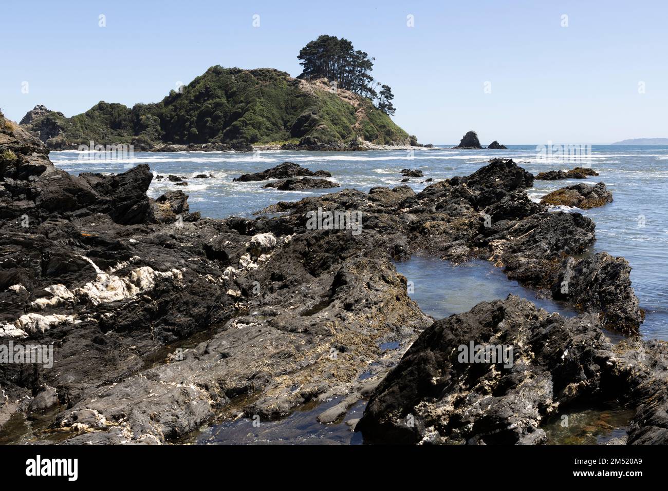 Isla Maiquillahue and big, serrated rocks in the Pacific Ocean of Chile ...