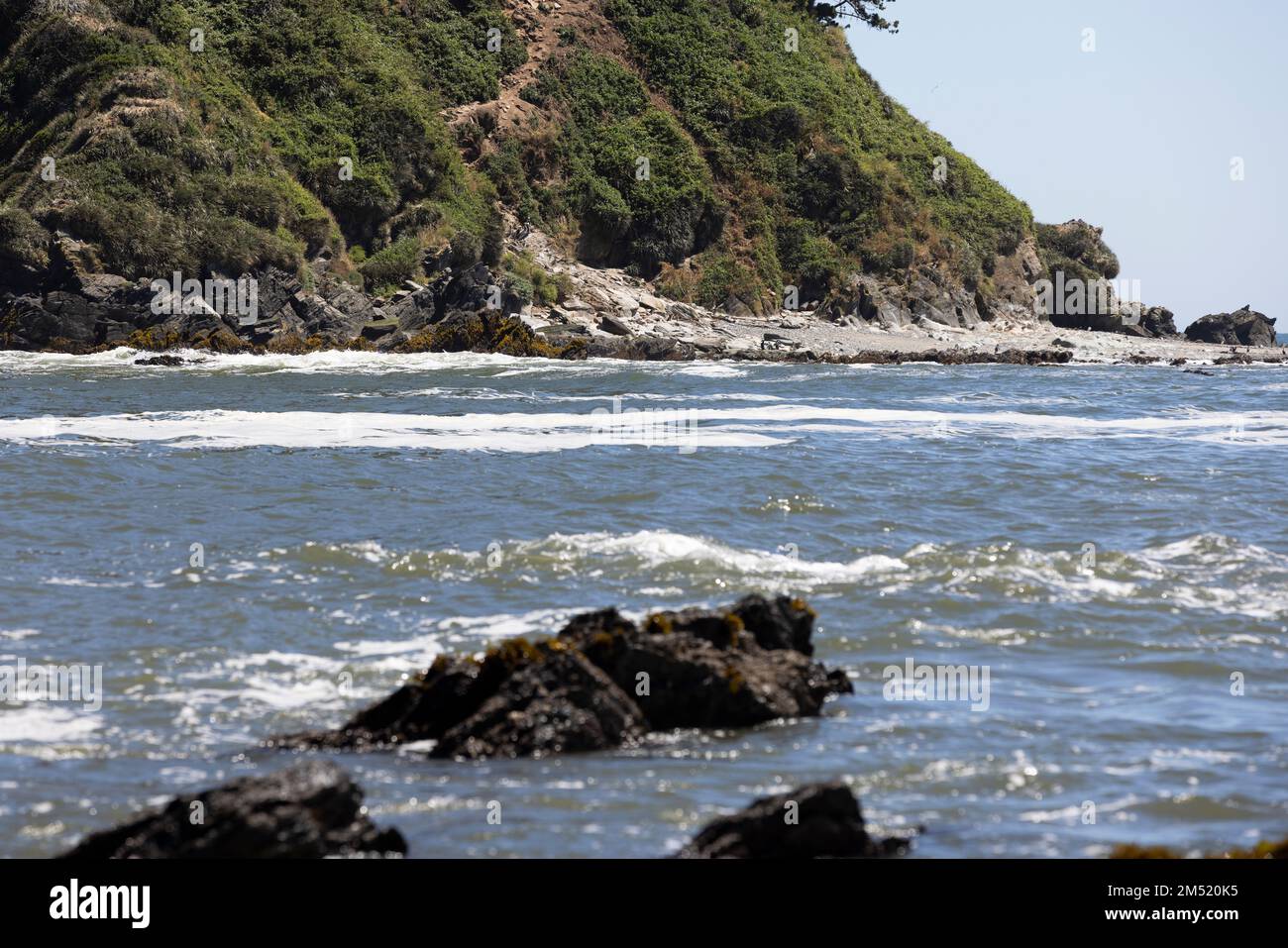 Isla Maiquillahue and big, serrated rocks in the Pacific Ocean of Chile ...