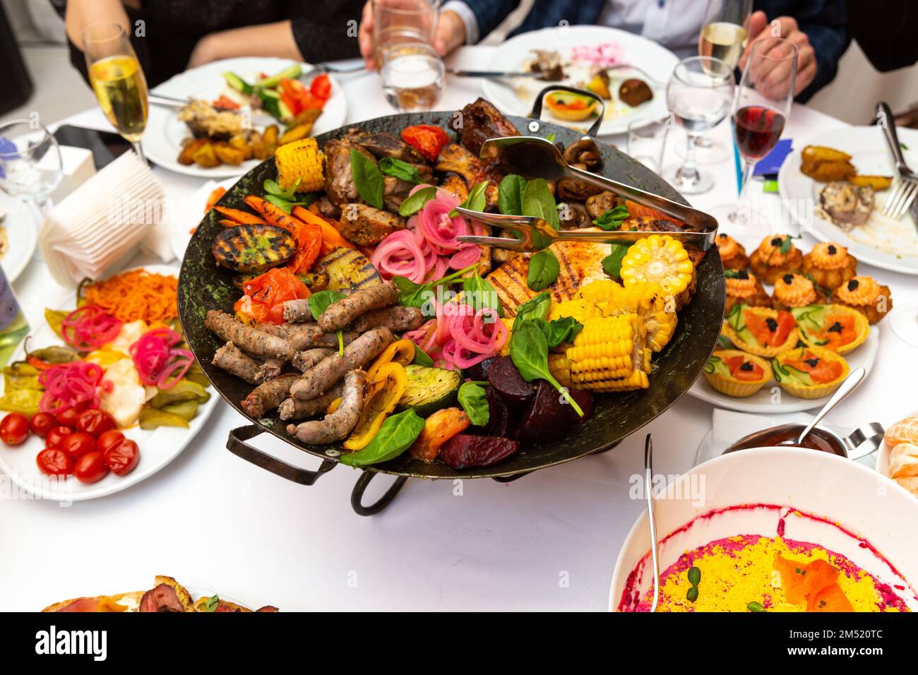 Assorted meat and vegetables, fried in a wok, set on a bowl with hot ...