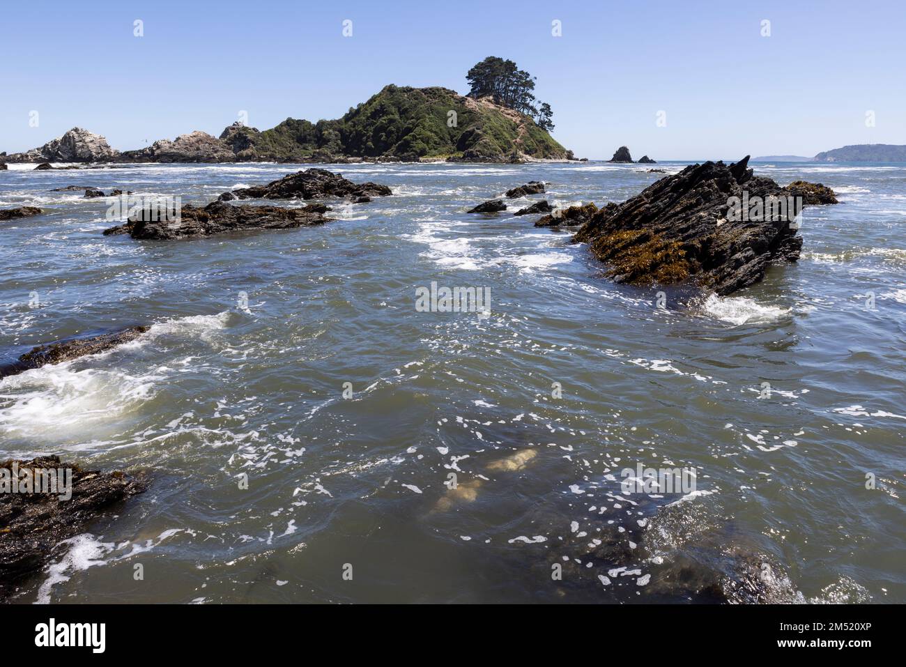 Isla Maiquillahue and big, serrated rocks in the Pacific Ocean of Chile ...