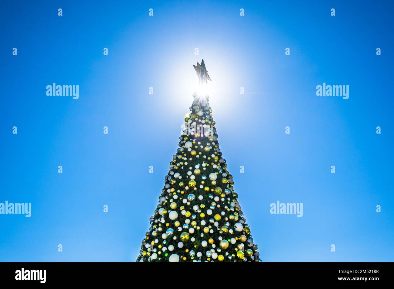 View of a heavy decorated Christmas tree with golden, silver, white ...