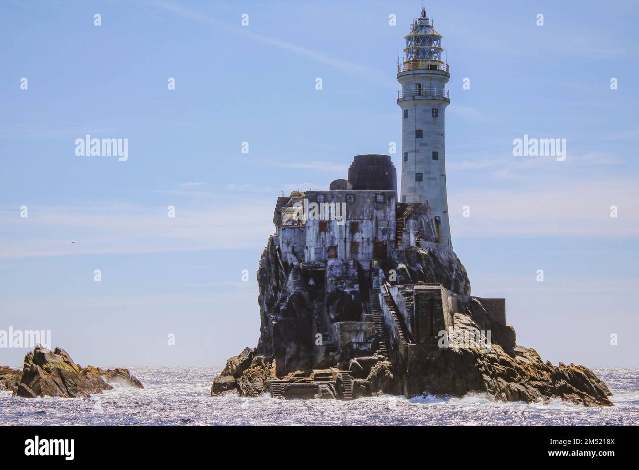 A scenic view of Fastnet lighthouse located on a rocky island in County ...