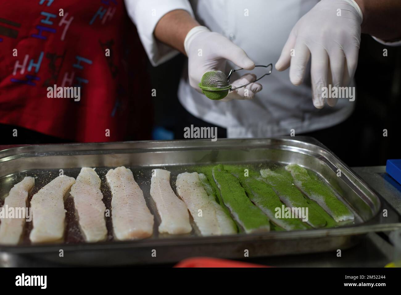 The chef cooking sole. Marinating fish with a mixture of 5 spices ...