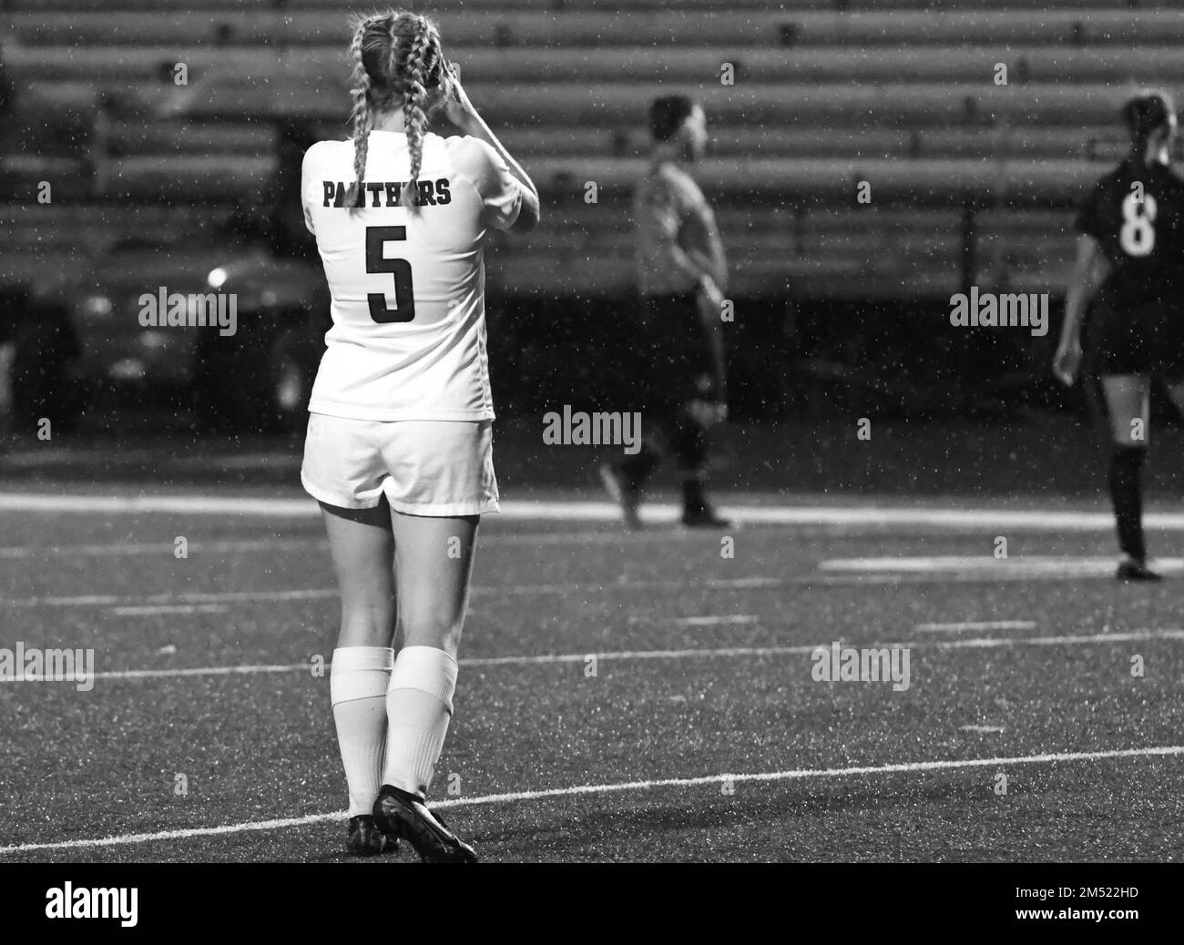A female soccer player showing emotion after losing a match in black ...