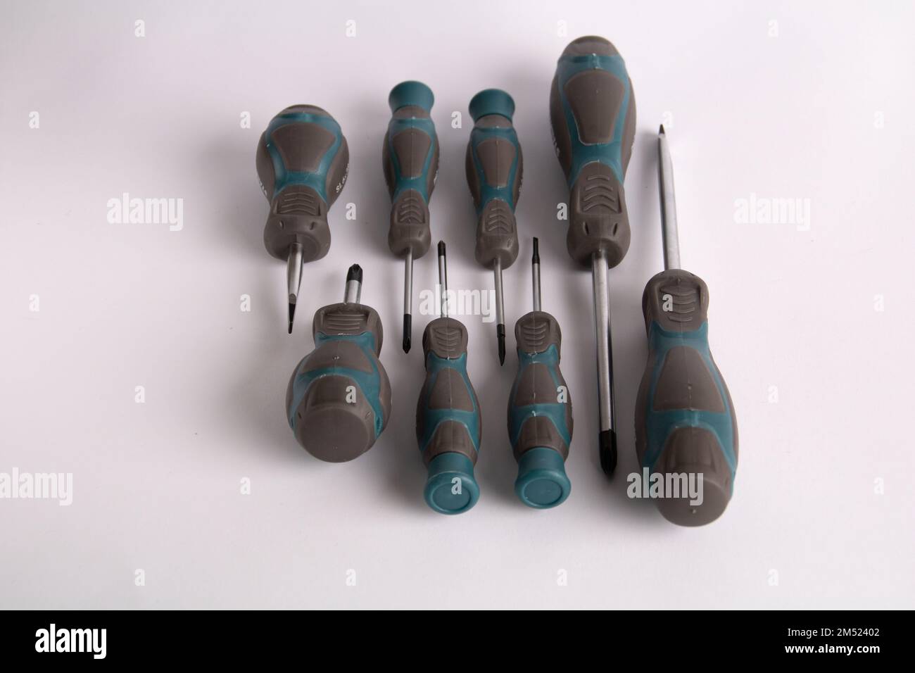 photo set of screwdrivers lying next to each other on a white ...