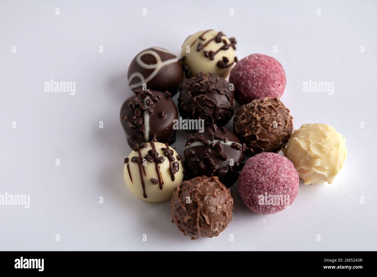 photo of a lot of chocolates on a white background Stock Photo - Alamy