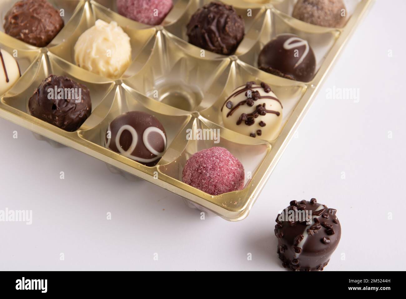 photo chocolates in a package one candy lies next to the white ...