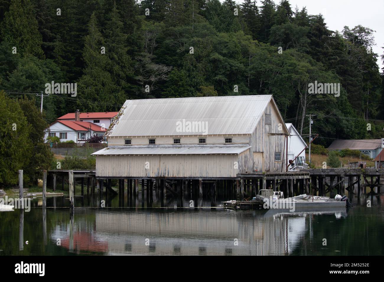 Fishboat wharf and shed with reflection in water at Sointula, Malcolm ...