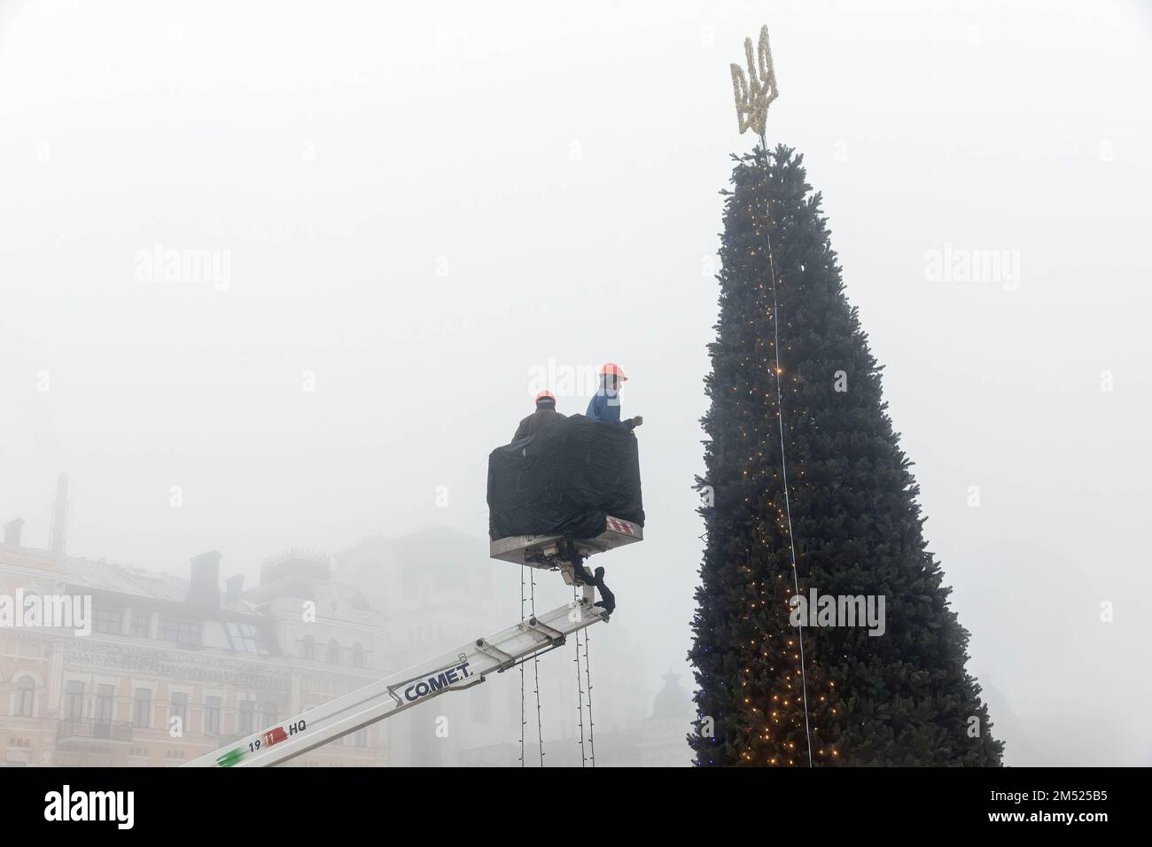 Workers set up and decorate a Christmas tree on Sofiyivska Square in ...